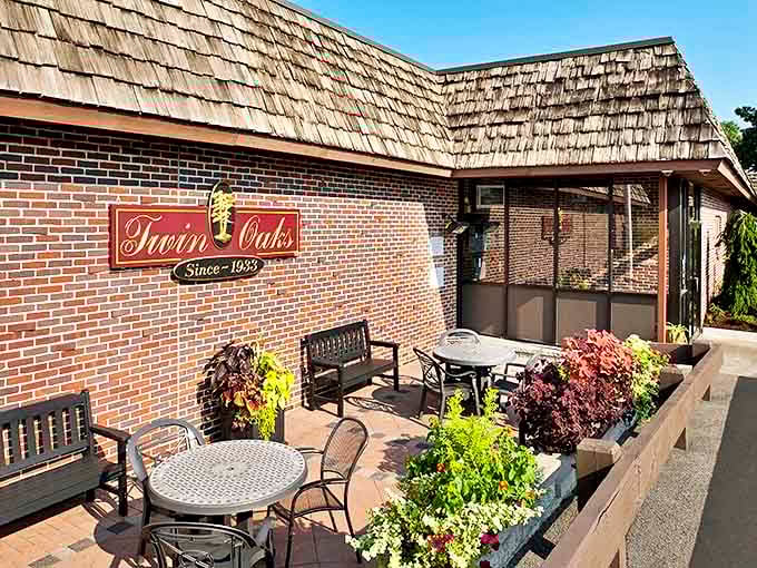 The brick façade of Twin Oaks stands proudly in Cranston, a culinary fortress where Rhode Island food dreams come true since 1933.