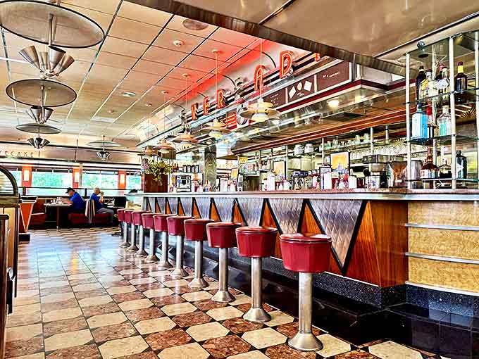 The counter where dreams come true and calories don't count. Those red stools have witnessed countless coffee refills and life stories.