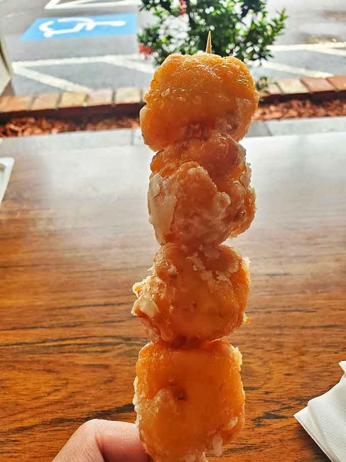 These golden-fried cascaron balls stacked like a savory Jenga tower are proof that some of life's greatest pleasures come on a stick.