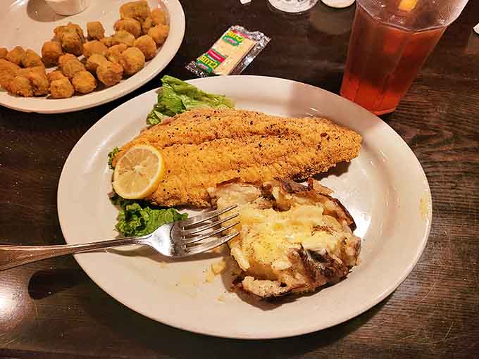Cornmeal-crusted catfish that tastes like it was swimming this morning, paired with a baked potato that's practically begging to be devoured.