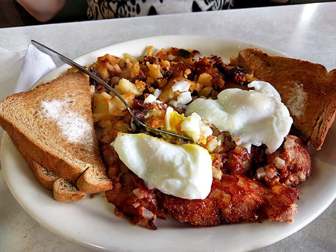 Corned beef hash with perfectly poached eggs &ndash; where yesterday's dinner becomes today's breakfast triumph in a delicious time-travel experiment.