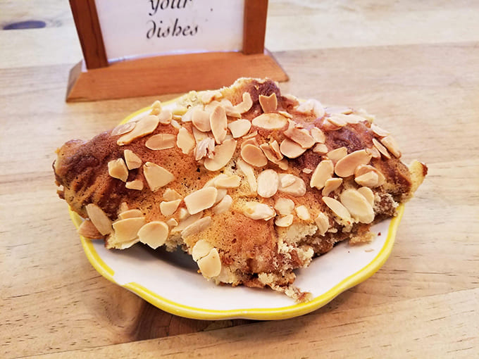 This almond croissant isn't just breakfast &ndash; it's architecture, engineering, and art, topped with a shower of nuts that seal the deal.