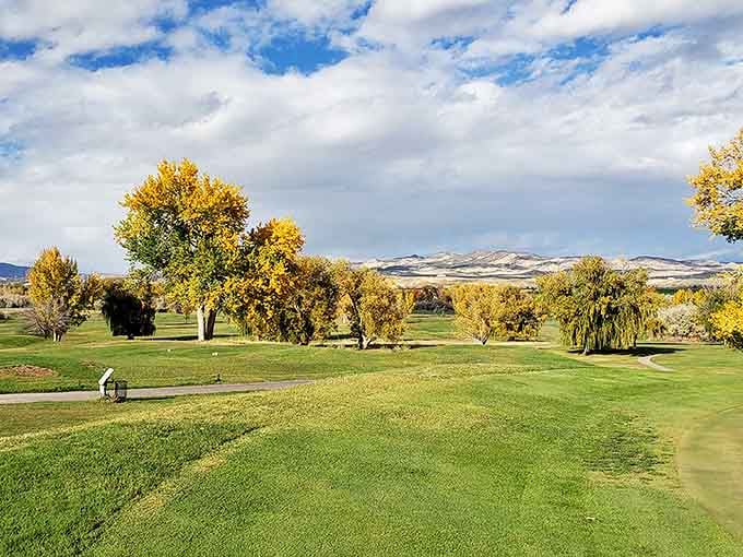 Dinaland Golf Course showcases fall's golden palette against mountain backdrops, where even a terrible swing looks magnificent in such scenery.