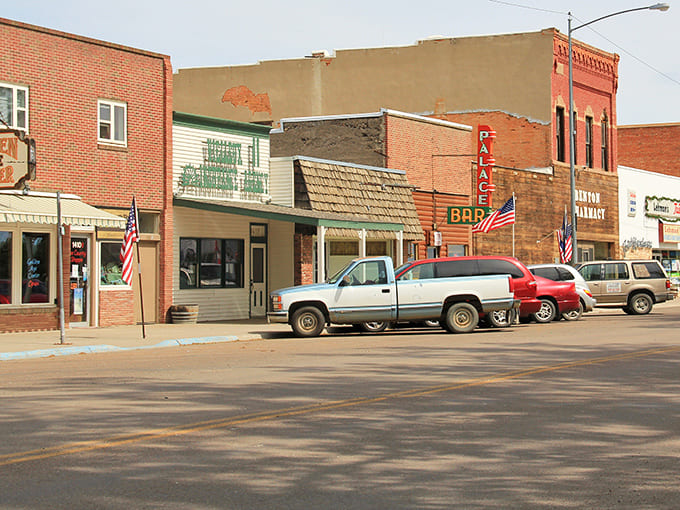 American flags flutter along Front Street, where the architecture tells stories that history books only summarize.