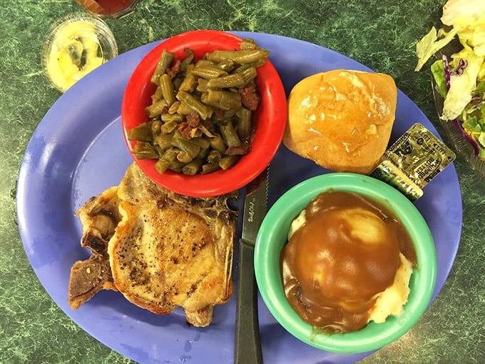 Southern comfort on a plate &ndash; a perfectly grilled pork chop with green beans and mashed potatoes swimming in gravy that could solve world peace.