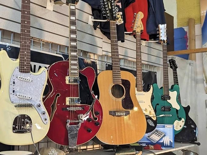 Six-string stories hanging in formation, each guitar carrying the ghost notes of previous owners and songs yet to be played.