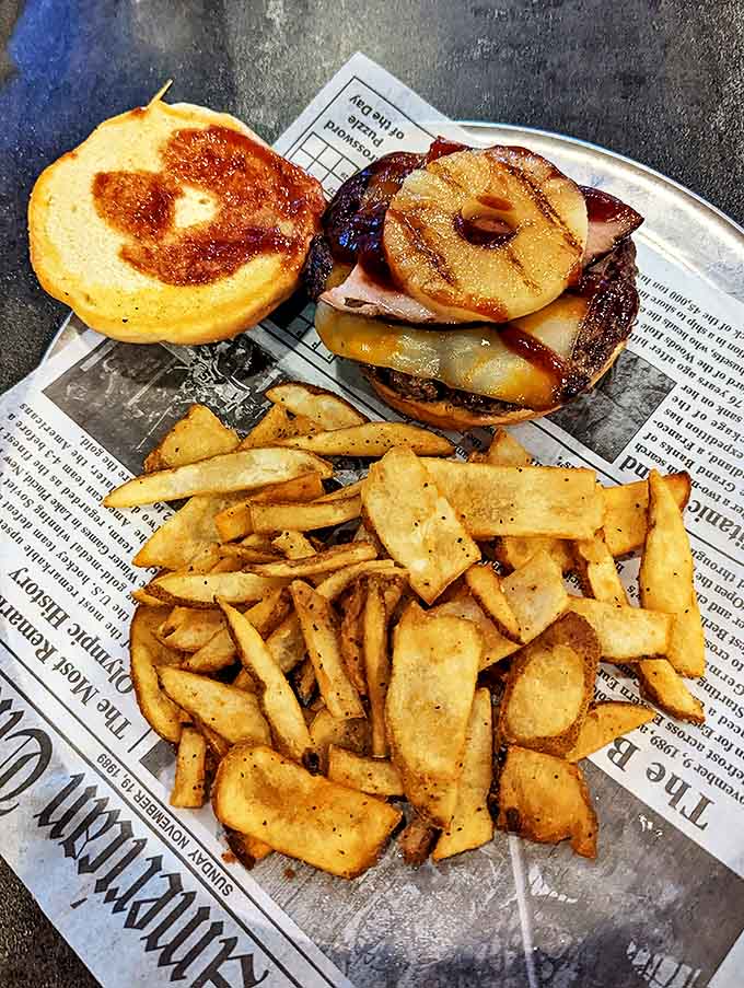 The Hawaiian Burger with grilled pineapple performs the culinary equivalent of putting a lei around your taste buds and taking them on vacation.