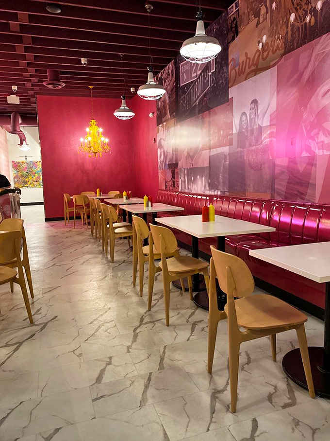 Red banquettes, golden chandeliers, and pink walls create a dining room that feels like Wes Anderson designed your favorite diner.