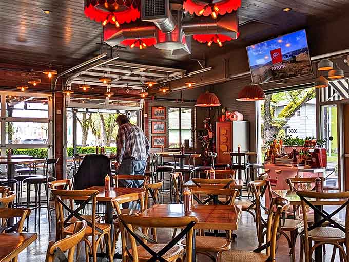Morning light streams through windows illuminating wooden tables waiting for the day's barbecue pilgrims. This casual vibe is exactly what great food deserves.
