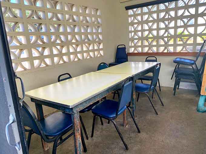 The dining room's decorative block wall filters Hawaiian sunlight like nature's stained glass. Simple beauty in a place that prioritizes substance.