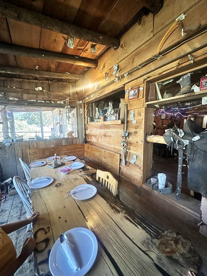 Every inch of wall space tells a story, from the weathered wood to the carefully arranged place settings awaiting the next hungry travelers.