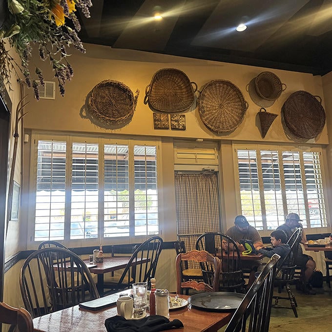 Woven baskets adorn walls where conversations flow as freely as the coffee&mdash;a dining room that feels like a warm hug.