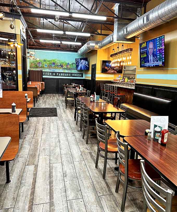 Exposed ductwork meets warm wood tones in this dining room that says, "Stay awhile, there's more coffee coming."
