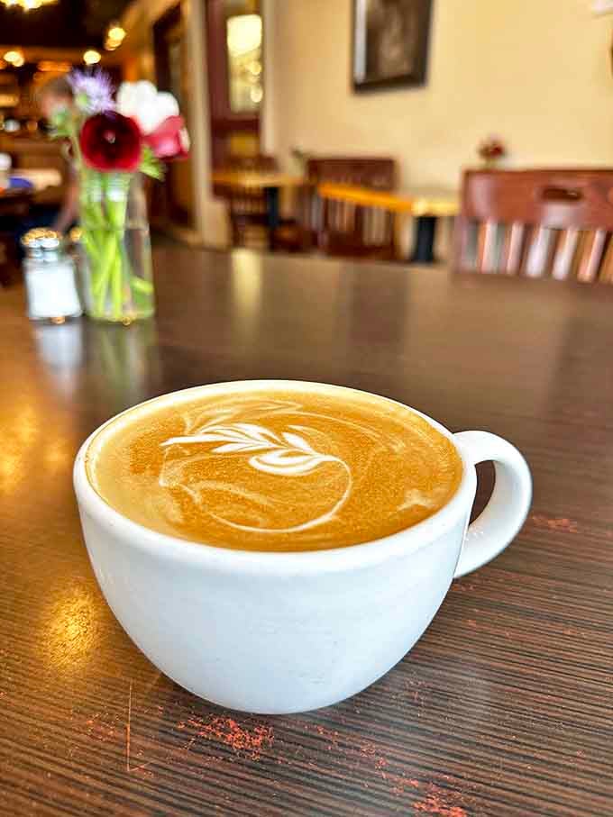 Latte art so pretty you almost don't want to drink it. Almost. The delicate leaf pattern floating on perfectly steamed milk is ephemeral coffee poetry.