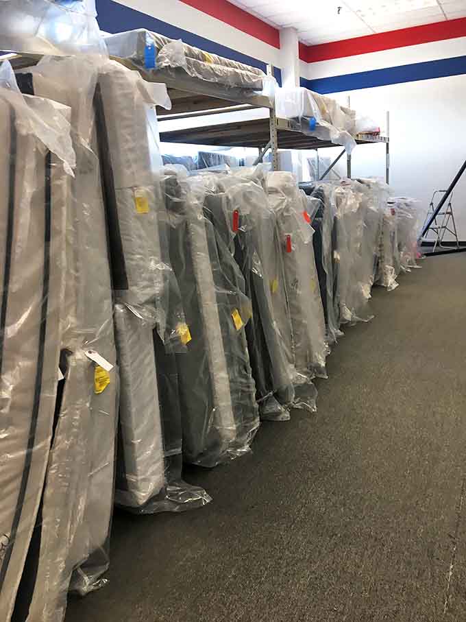 Mattresses standing at attention, wrapped and ready for new dreams. Sleep never looked so affordable.