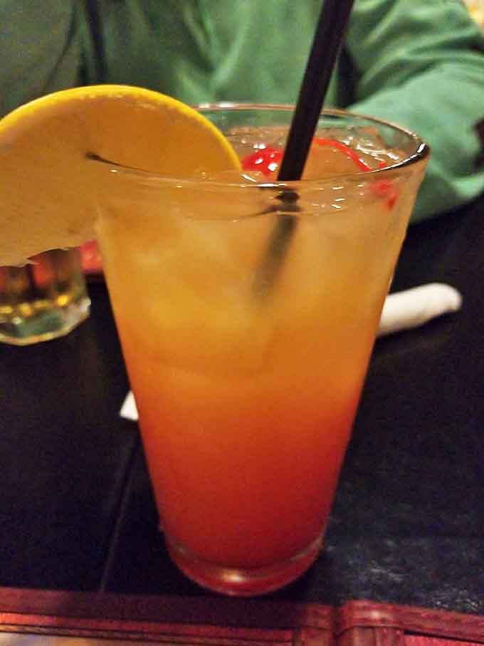 This sunset-colored cocktail isn't just a drink; it's liquid vacation in a glass, complete with citrus garnish and the promise of a good time.