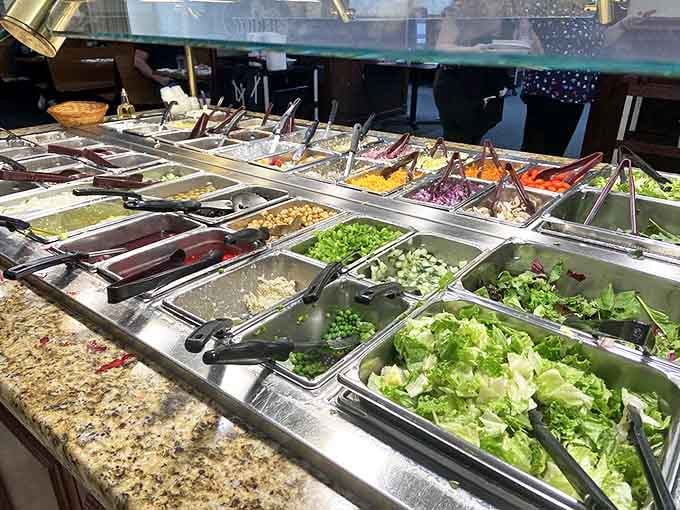 The salad bar: where virtuous intentions meet delicious reality in a rainbow of fresh vegetables and prepared salads.