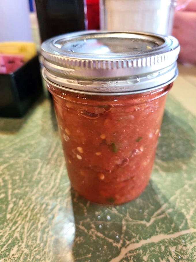House-made salsa in a mason jar&mdash;the kind of fresh, chunky Texas handshake that makes store-bought versions hang their heads in shame.