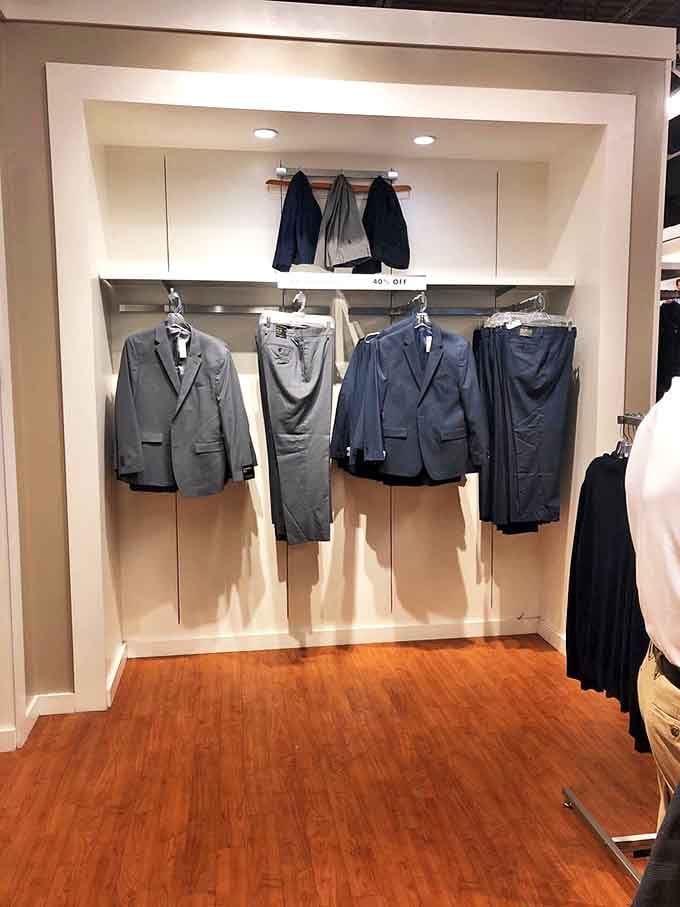 Men's suits hanging with quiet dignity, patiently waiting to transform someone into the best-dressed person at the next wedding or job interview.