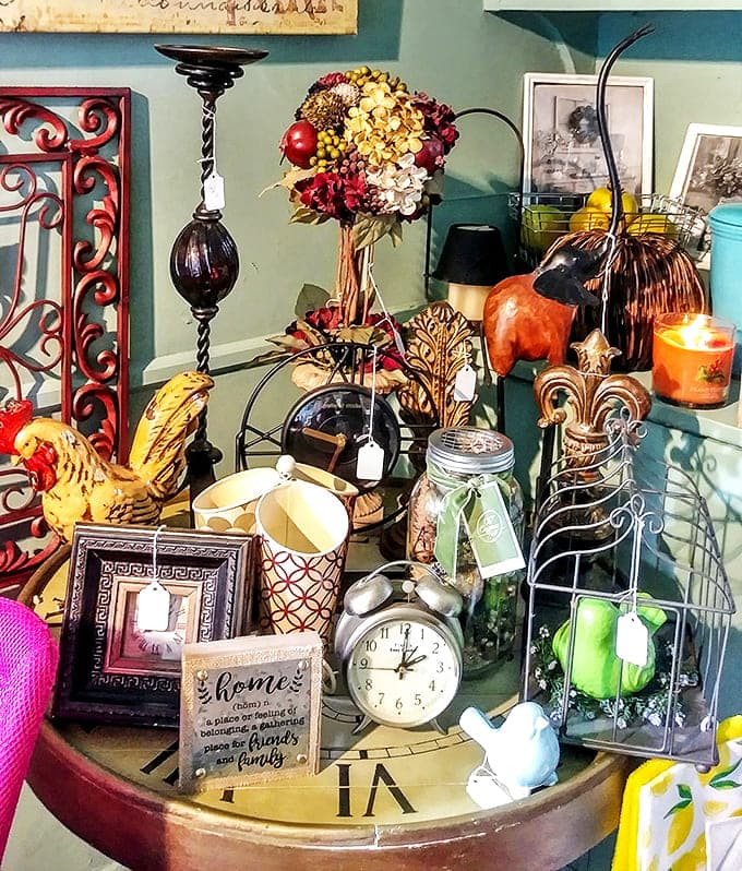 Time-traveling treasure trove! This collection of vintage clocks, roosters, and inspirational signs could transform any house into Grandma's favorite room.