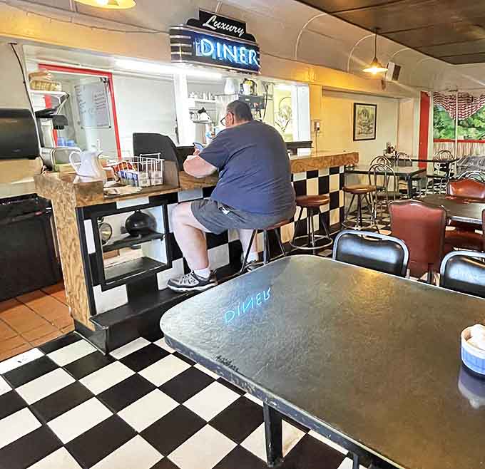 Counter seating: where solo diners become part of the Luxury Diner family and regulars exchange local wisdom between coffee refills.