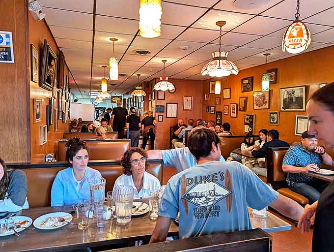 The universal language of pizza appreciation transcends all differences. Notice nobody's looking at their phones&mdash;the pie demands full attention.