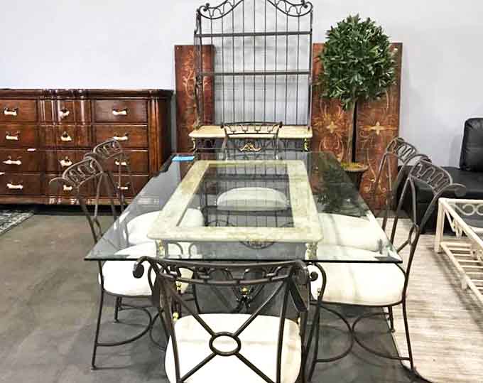 Elegant dining awaits! This glass and wrought iron table set could host your next dinner party without revealing its thrifty origins.