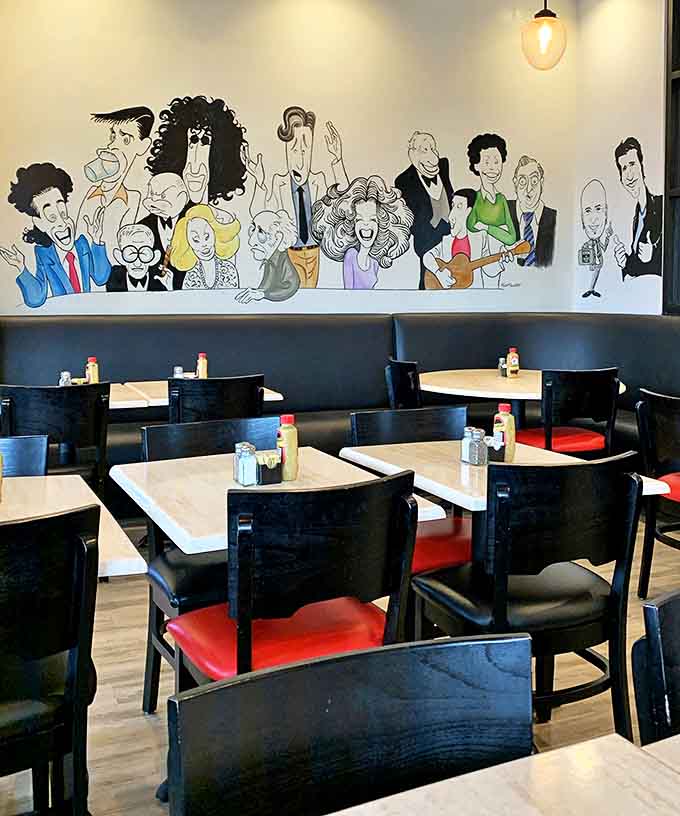 The wall mural features comedy legends watching over your meal &ndash; silent guardians ensuring your sandwich experience lives up to proper deli standards.