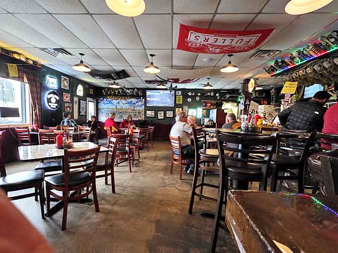 The dining room hums with conversation and clinking glasses, creating that magical pub atmosphere where strangers become friends and friends become family over good food and drink.