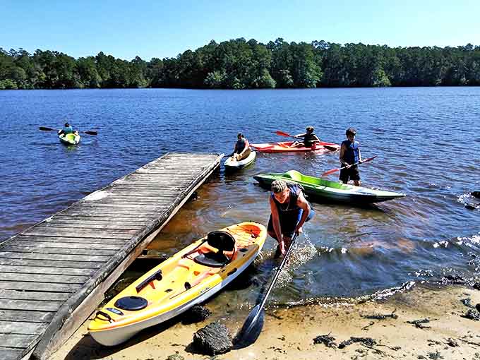 Kayaking adventures begin at this weathered dock, where colorful vessels wait to transport you across Geiger Lake's glassy surface.