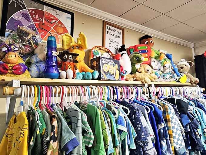 Stuffed animals stand guard over tiny t-shirts and onesies, a nostalgic reminder that kids outgrow clothes faster than parents can say "growth spurt."