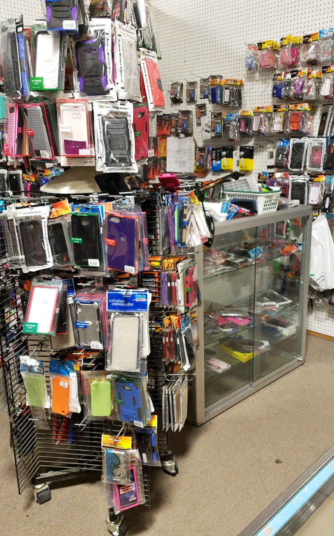 The modern meets the vintage marketplace&mdash;where smartphone cases hang like colorful technological cocoons waiting for their butterfly moment.