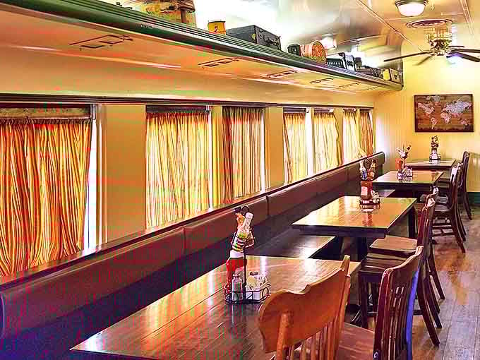 Bright striped curtains let in just enough light to make the wooden booths glow with warmth, creating the perfect setting for both intimate conversations and boisterous family meals.