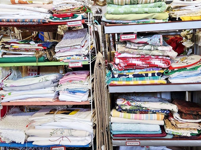 Grandmother's linens, meticulously folded and waiting for new tables to adorn. Each pattern tells the story of dinner parties and Sunday gatherings long past.