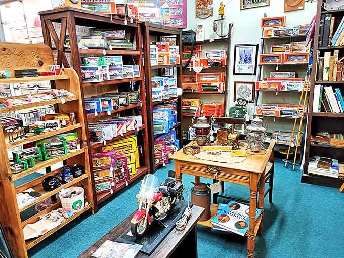 A collector's corner where vintage toys and model vehicles await their next adventure. That motorcycle probably costs more now than when it was life-sized in the showroom.