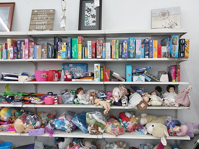 Childhood nostalgia by the shelf. Board games with missing pieces and dolls with stories to tell await their next adventure.