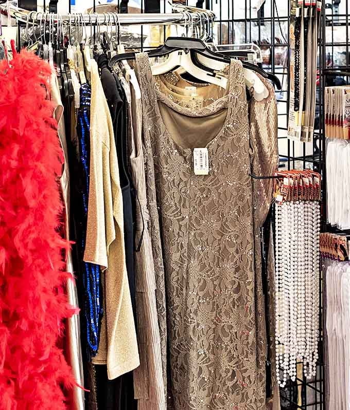 Elegant evening wear hangs patiently, waiting for its next gala. That lace dress could tell some stories.