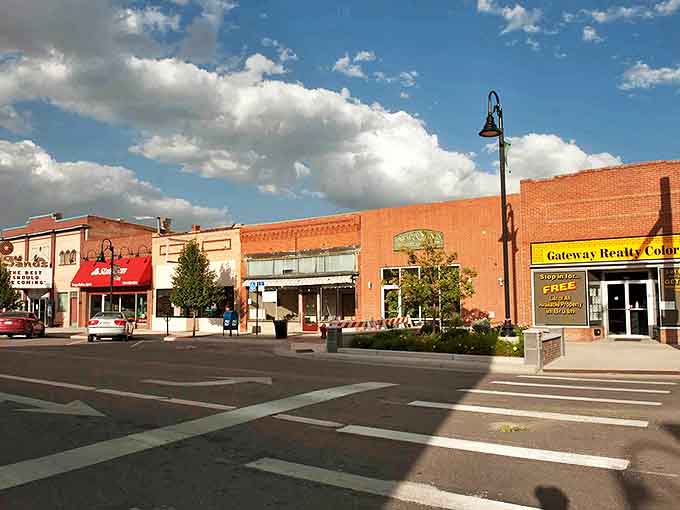 Warm brick buildings line Brush's Main Street, housing businesses where shopkeepers greet customers by name.