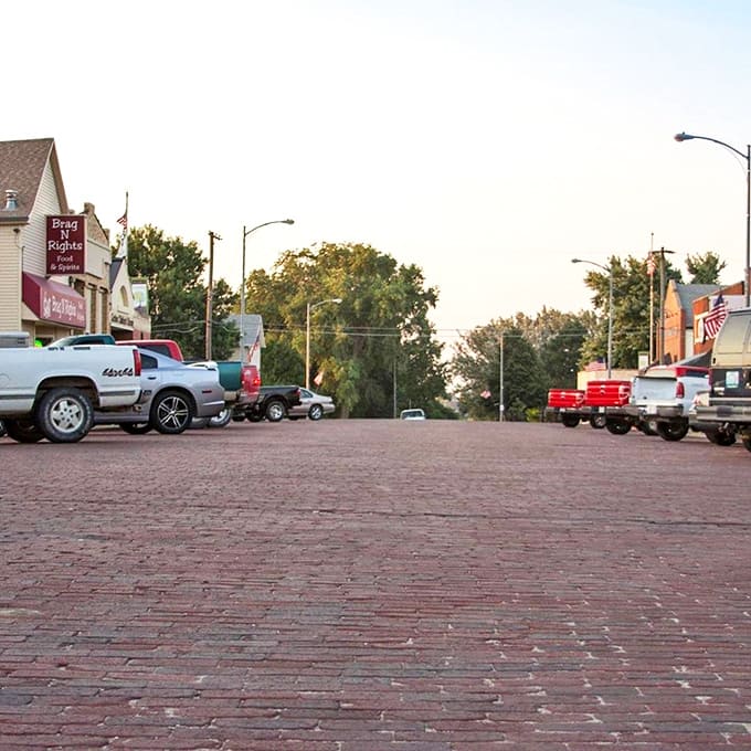Brick streets stretch toward the horizon in this peaceful Nebraska town, where pickup trucks line the curbs of a true Smallville-like setting.