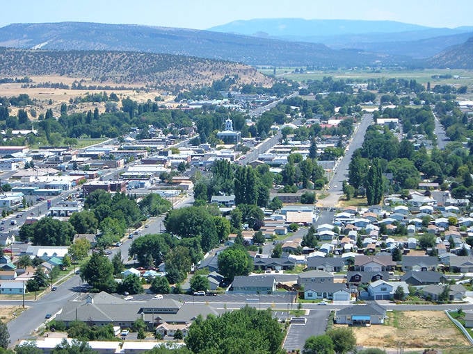 This aerial view shows Prineville's charming residential neighborhoods nestled between rolling hills, where your retirement dollars stretch much further.