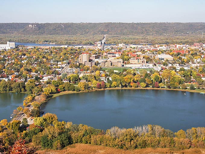 Fall colors frame Lake Winona like nature's own masterpiece, proving Minnesota knows how to dress for autumn's grand ball.