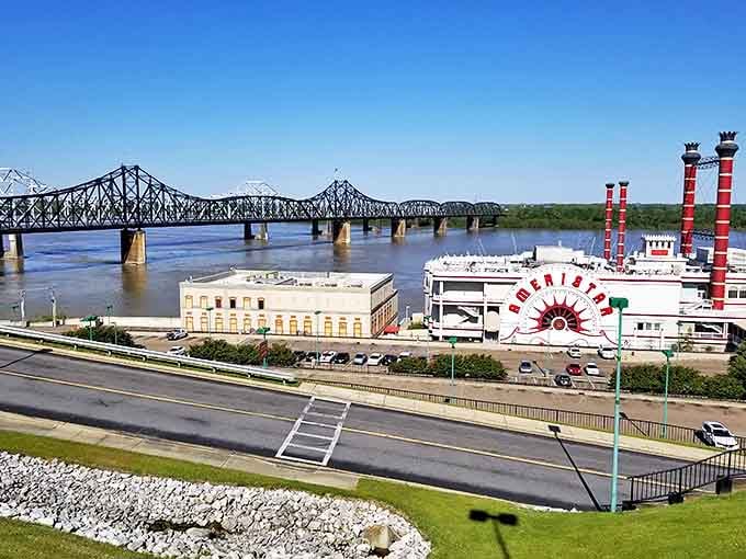 The Mississippi River flows beneath the iconic bridge, with the Ameristar riverboat casino offering entertainment that doesn't require a high-roller budget.