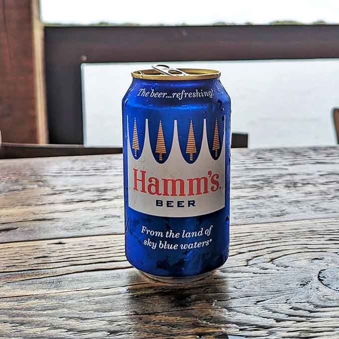 A cold Hamm's beer against weathered wood&mdash;sometimes the simplest pleasures really are the best, especially with a river view thrown in for free.