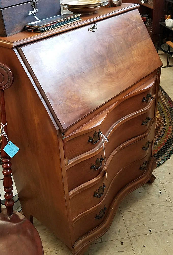 This secretary desk has probably seen more letters written than most email servers. Its curved drawers and warm wood tell tales of correspondence past.