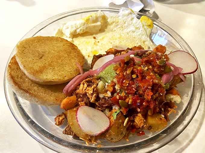 Brunch rebellion on a plate! English muffins playing host to a fiesta of tinga, radishes, and eggs &ndash; proof that breakfast rules were meant to be deliciously broken.