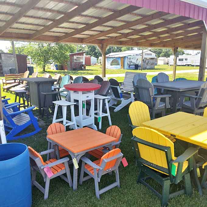 Adirondack chairs in carnival colors invite relaxation and conversation. These aren't just seats&mdash;they're summer evenings waiting to happen, with a cold drink in the cup holder.