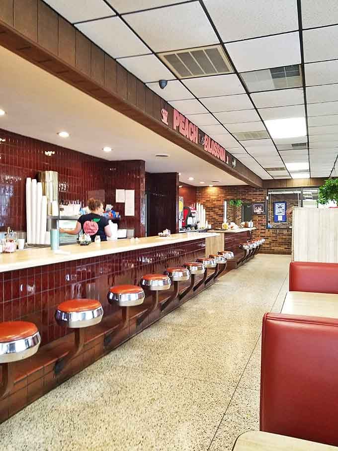 The counter where magic happens – where coffee cups are never empty and the staff knows the difference between "how are you" and "how ARE you."