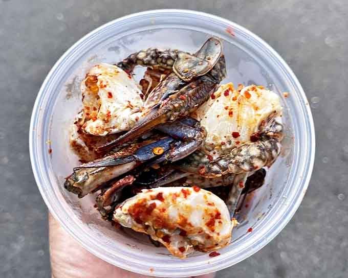 Tender morsels of crab glistening with spice&mdash;proof that sometimes the most memorable seafood comes in humble plastic containers rather than on fine china.