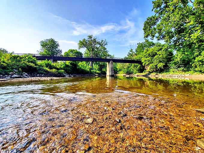The clear waters of the Vermilion River flow beneath this bridge, offering fishing spots that don't require a second mortgage.