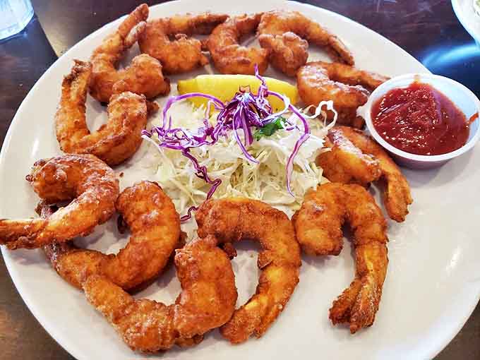 These golden fried shrimp form a perfect circle of deliciousness, like a seafood clock telling you it's time to indulge. The cocktail sauce adds just the right kick.